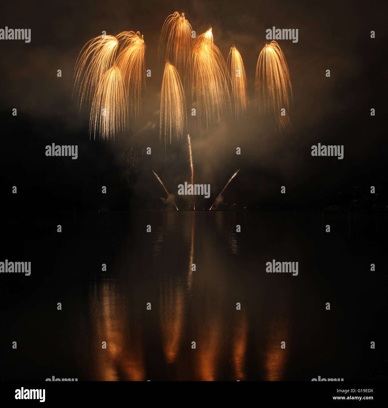 Colorful fireworks with reflection on lake and night sky in background ...