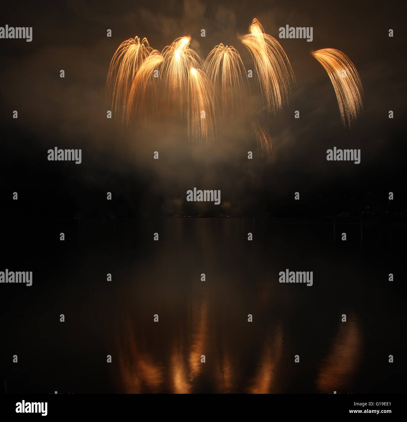 Colorful fireworks with reflection on lake and night sky in background ...