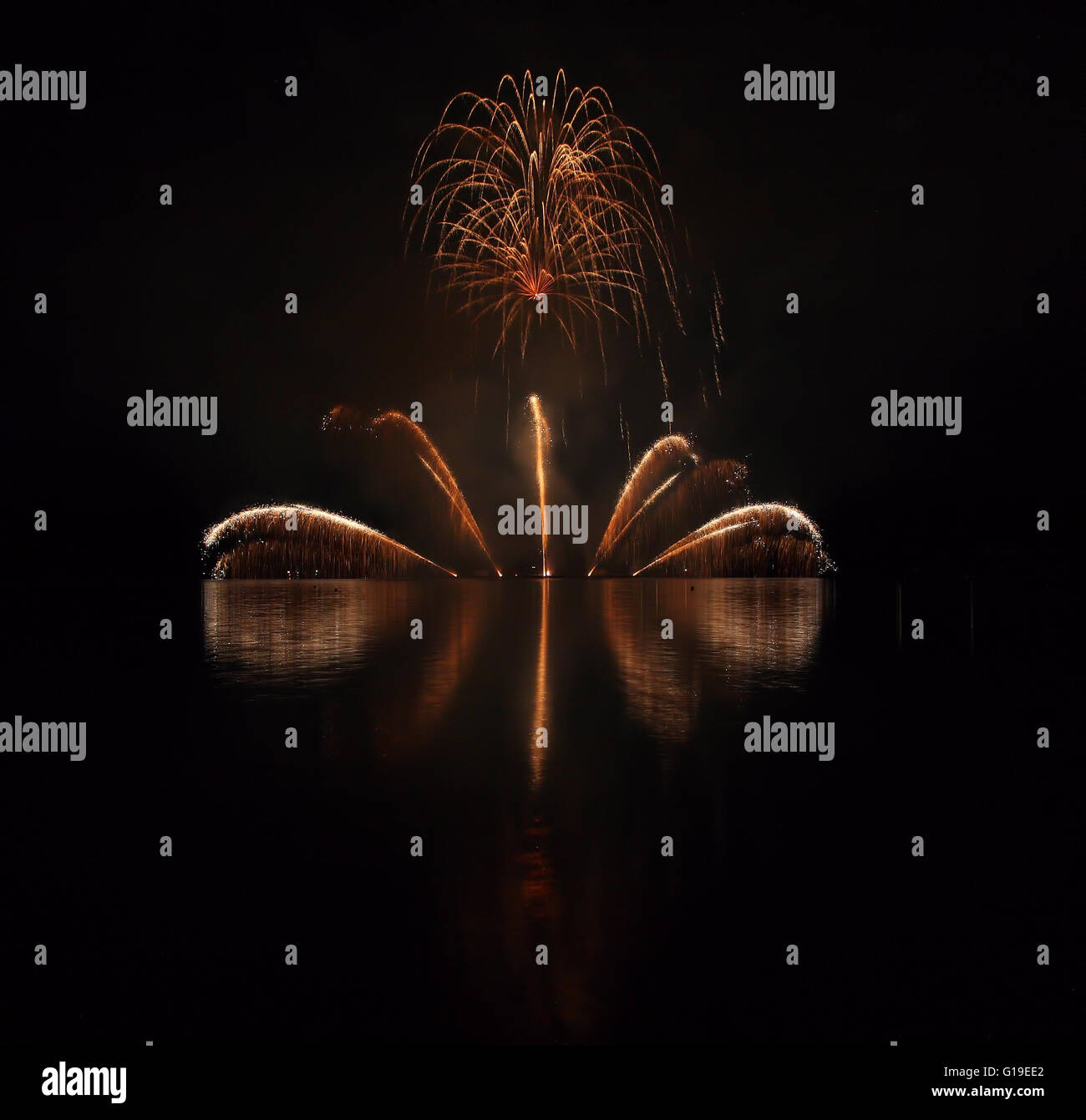 Colorful fireworks with reflection on lake and night sky in background ...