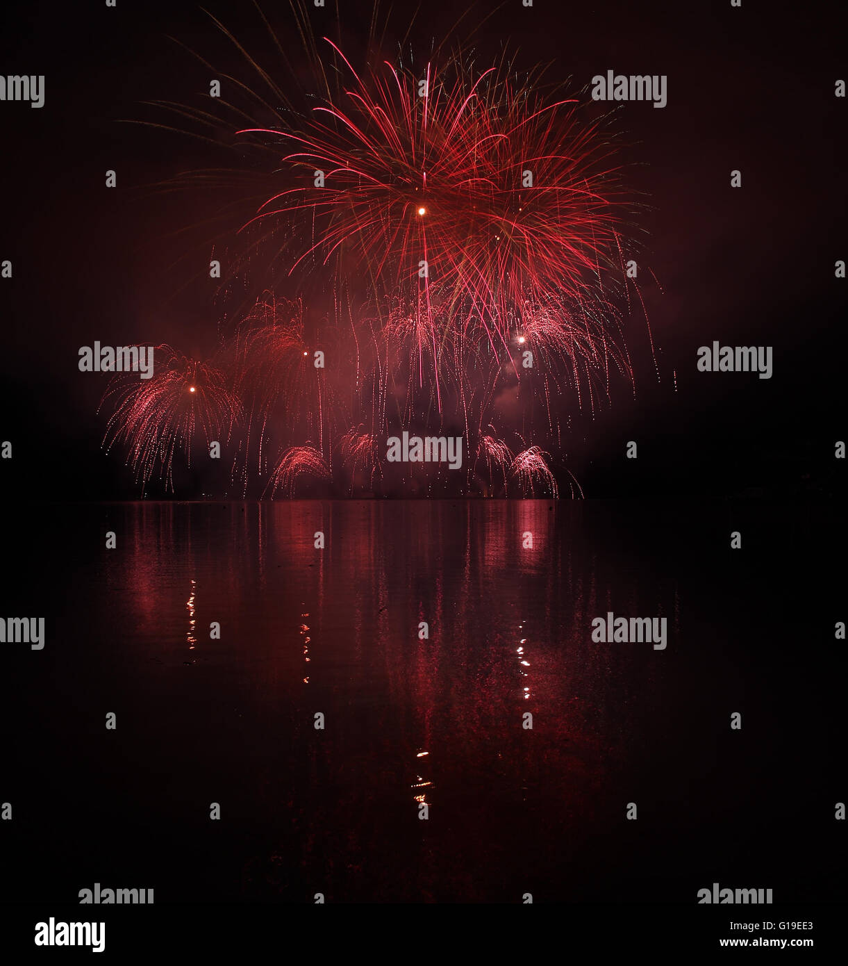 Colorful fireworks with reflection on lake and night sky in background ...