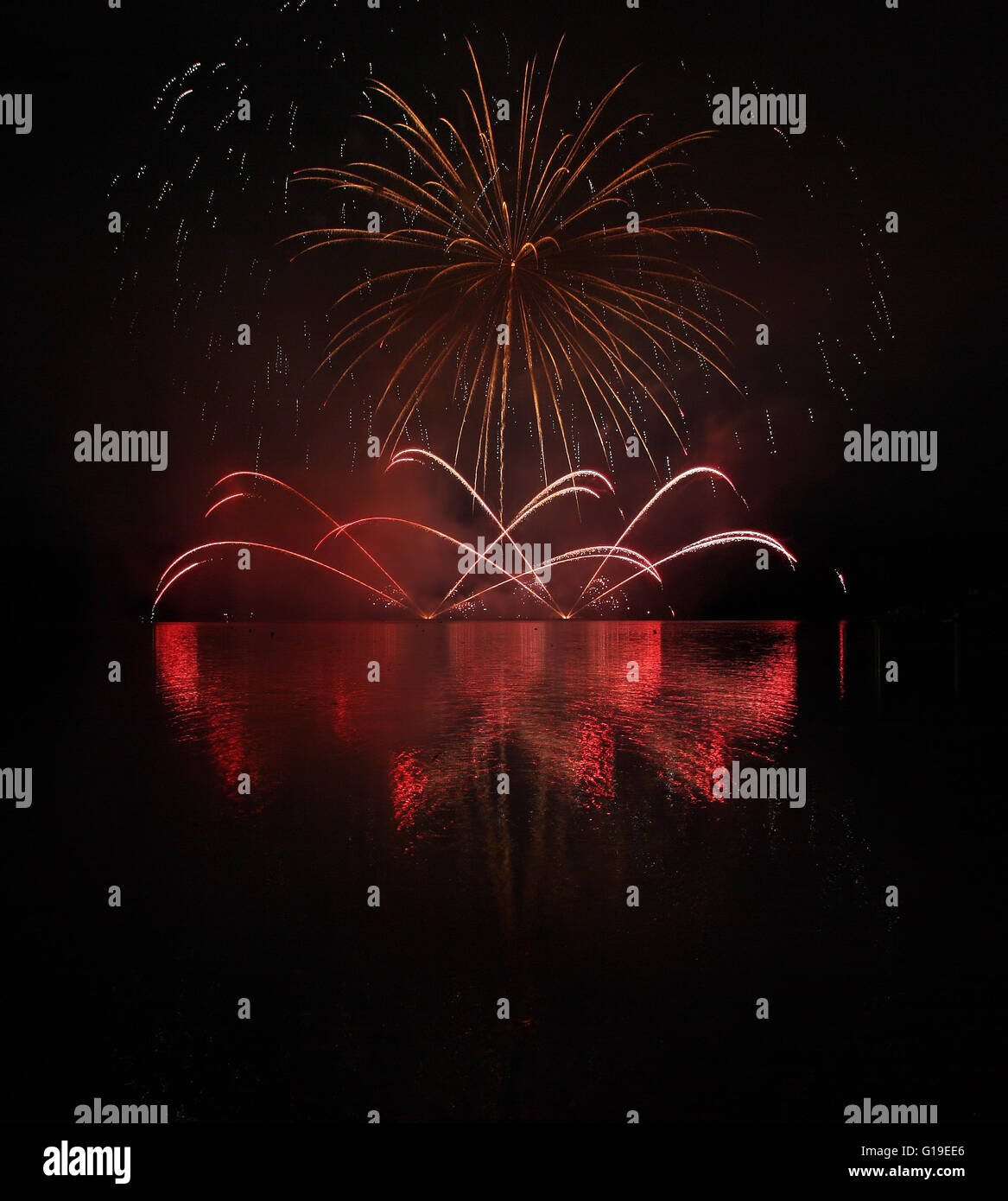 Colorful fireworks with reflection on lake and night sky in background ...