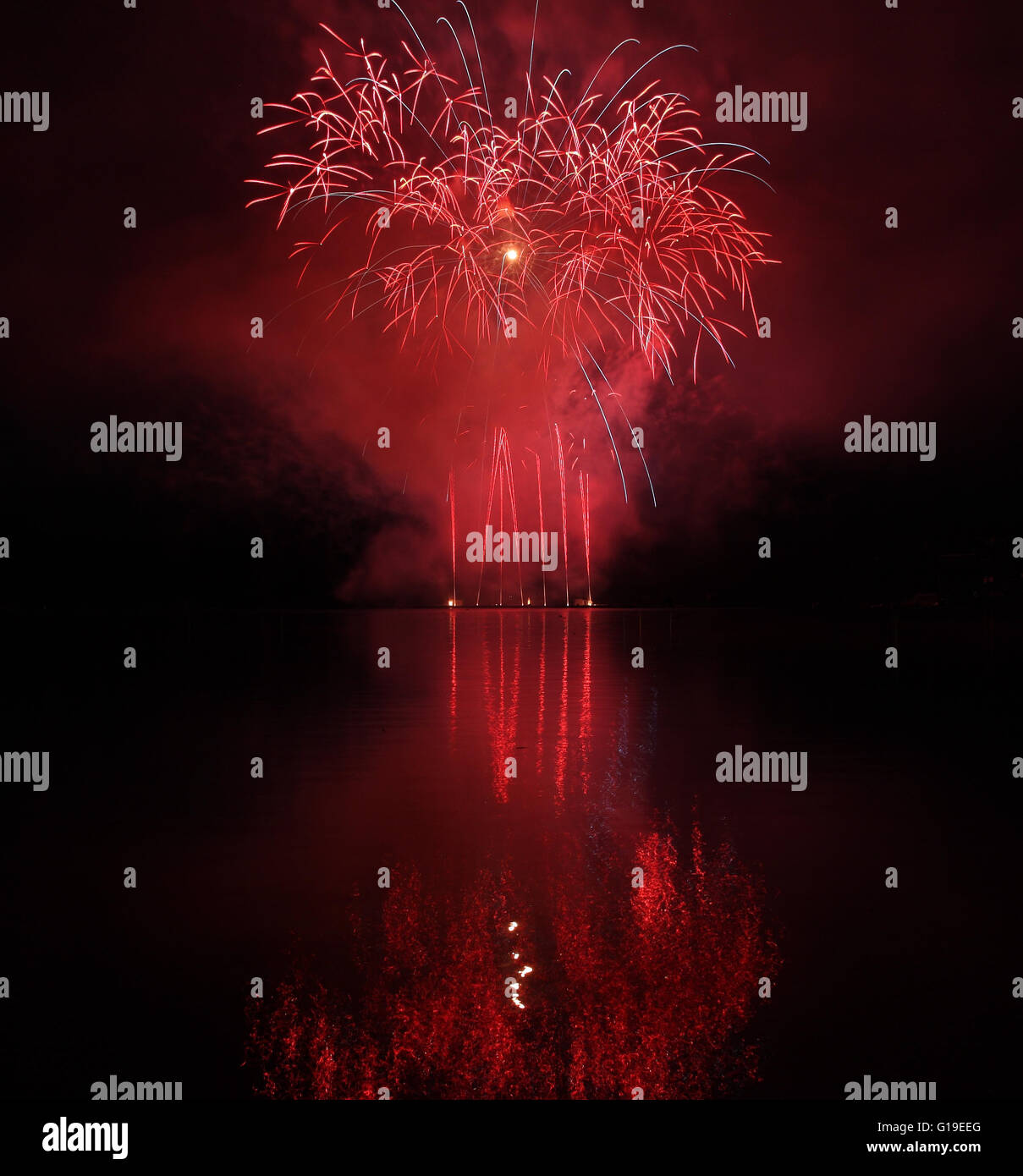 Colorful fireworks with reflection on lake and night sky in background ...