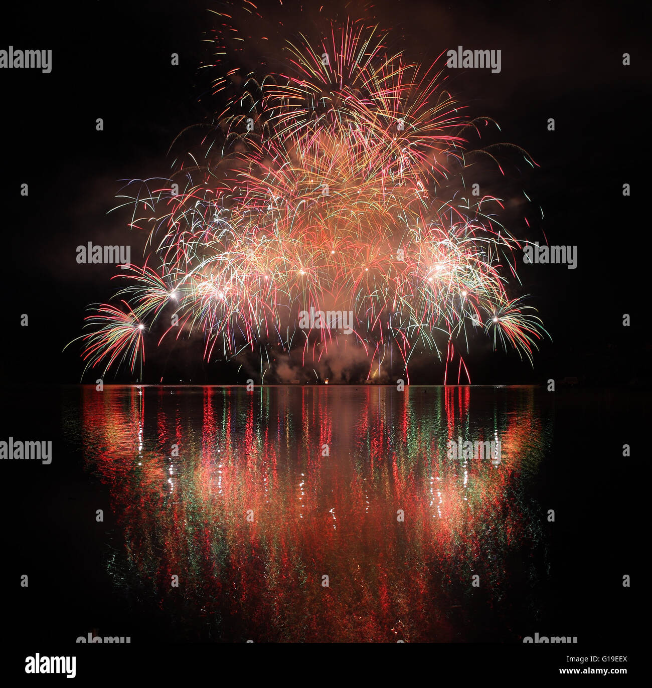 Colorful fireworks with reflection on lake and night sky in background ...
