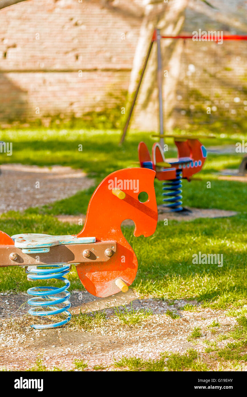 spring horses on a playground Stock Photo - Alamy