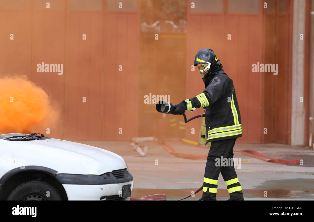 firemen during exercise to extinguish a fire in a car with foam Stock ...