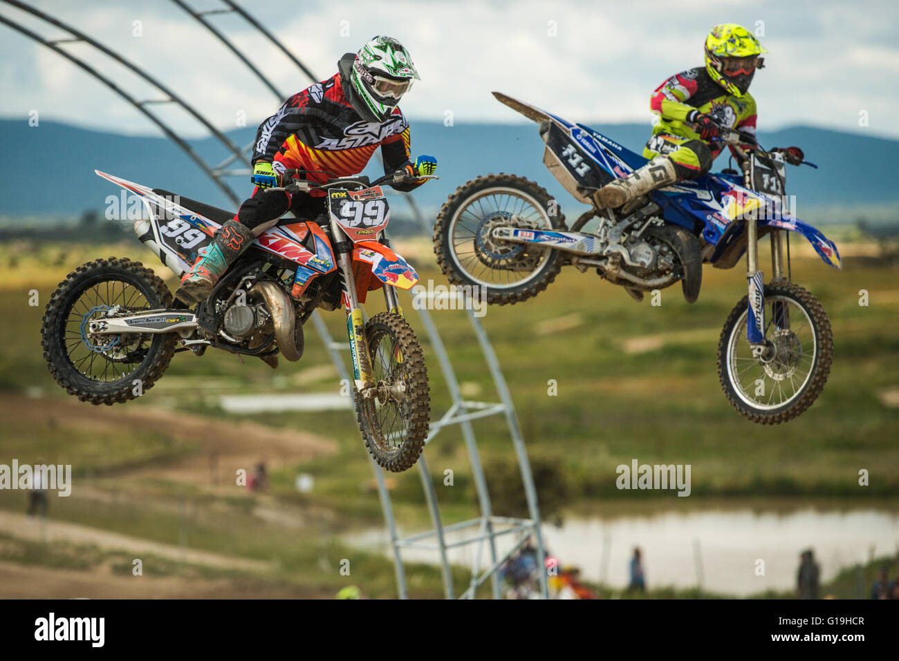 Two motorbikes jumping on a motocross competition Stock Photo - Alamy