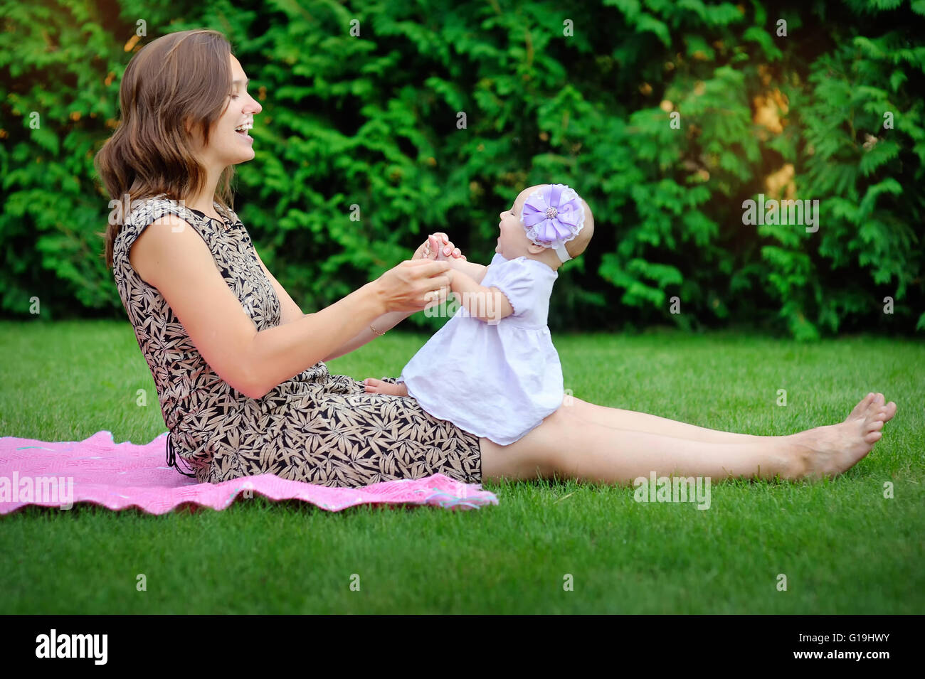 Beautiful Mother And Baby outdoors. Nature. Beauty Mum and her C Stock ...
