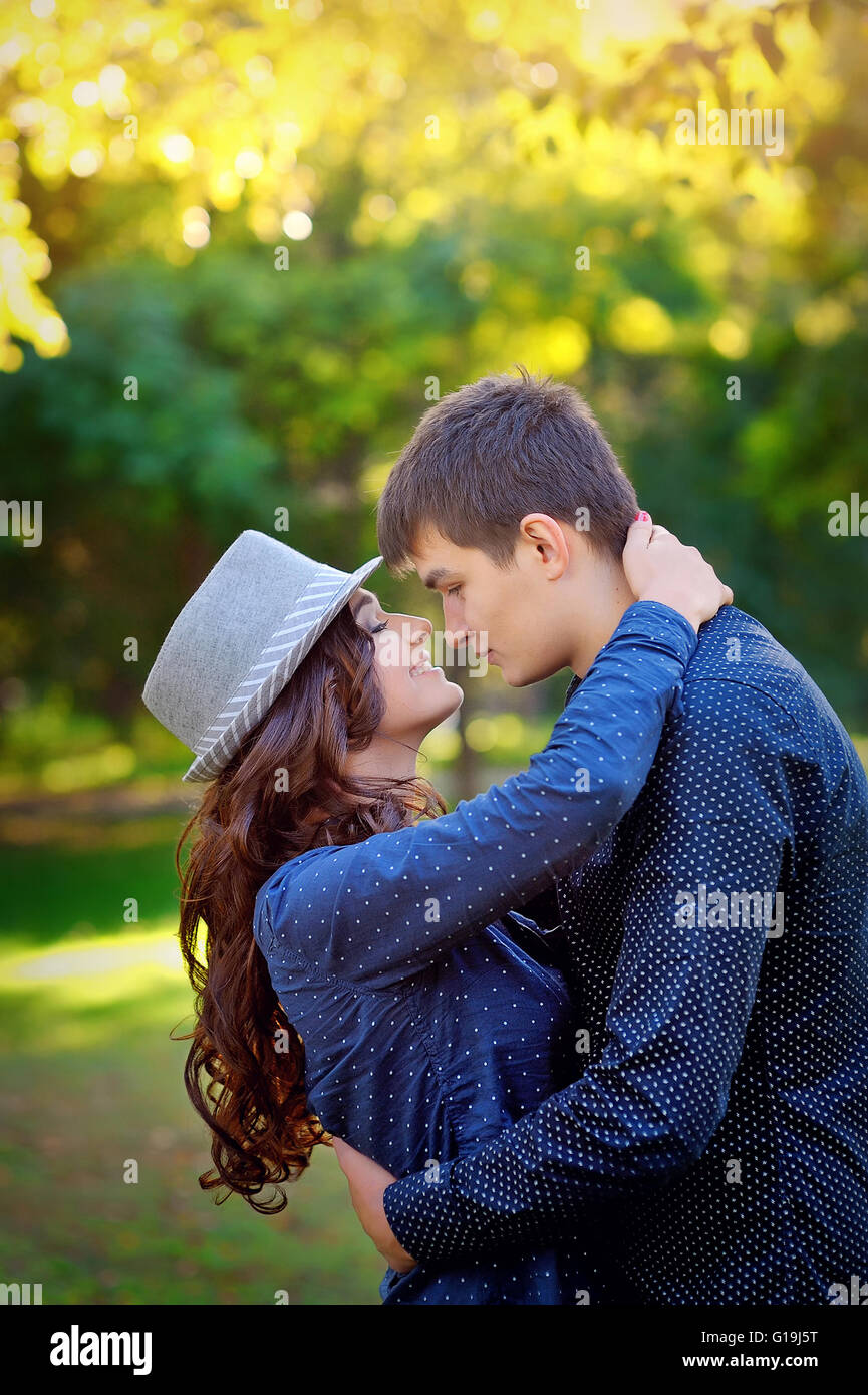Young couple in sunset embraced together Stock Photo - Alamy