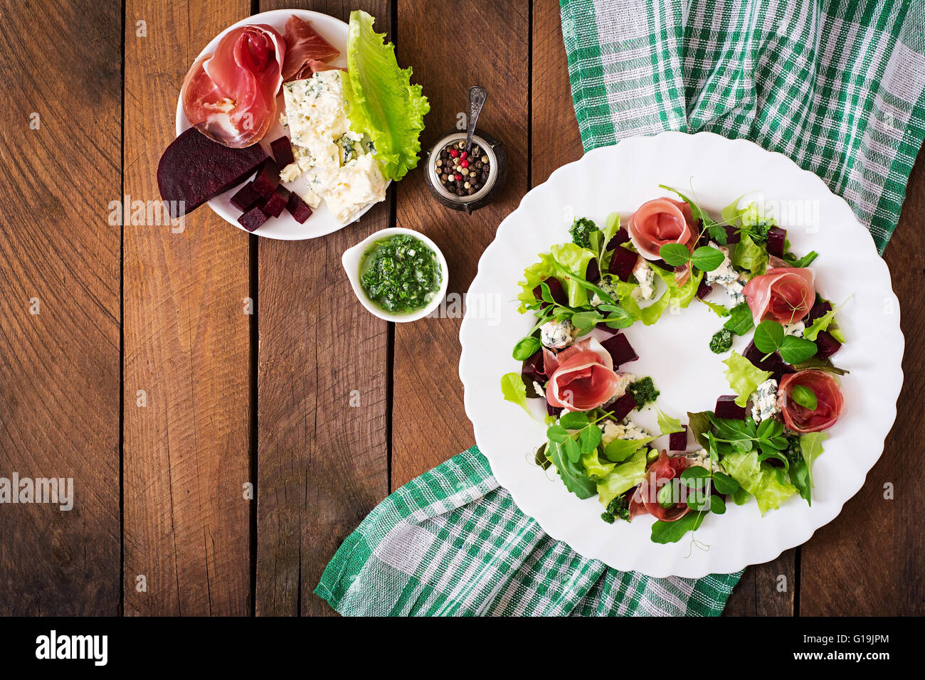 Salad with baked beet, blue cheese, ham and green mix with pesto. Top ...
