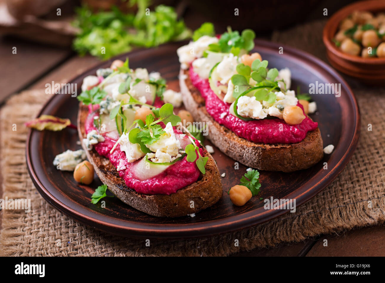 Vegan sandwiches with beetroot hummus, cucumber and blue cheese Stock ...