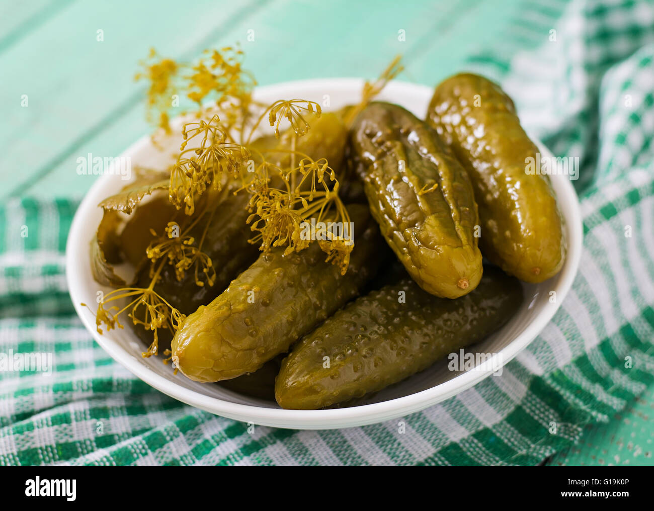 Pickled cucumbers on a light wooden background Stock Photo - Alamy