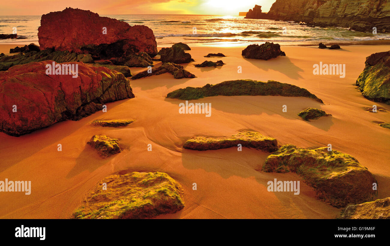 Portugal, Algarve: Last sun illuminating rocks and sand of beach Tonel ...