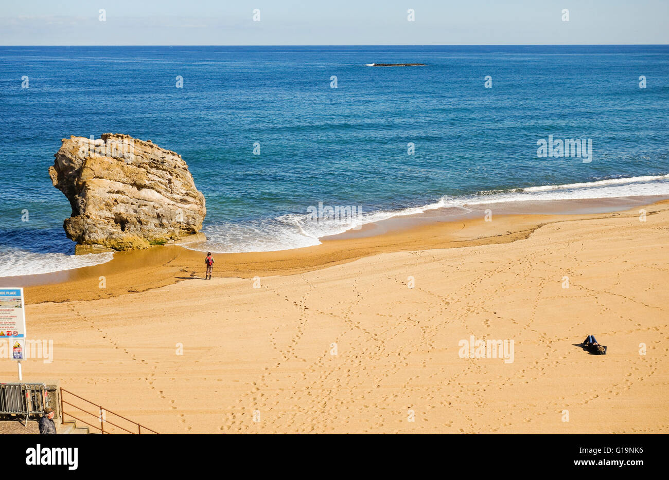 People around huge rock formation at Grande Plage, beach. Atlantic ...