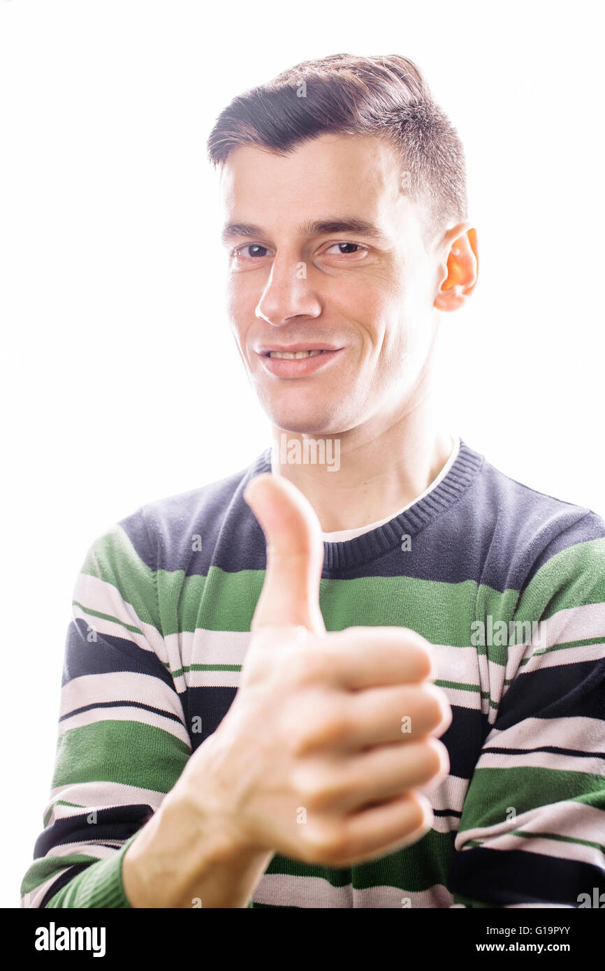 Portrait of a smart serious young man standing against white background ...