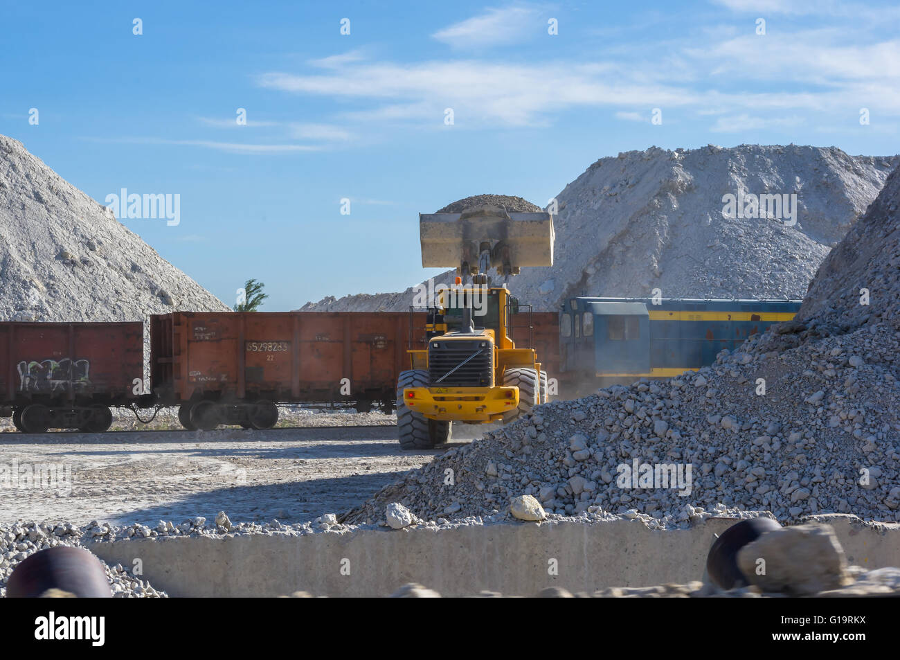 forklift - warehouse production in quarry blue clay on sky background ...