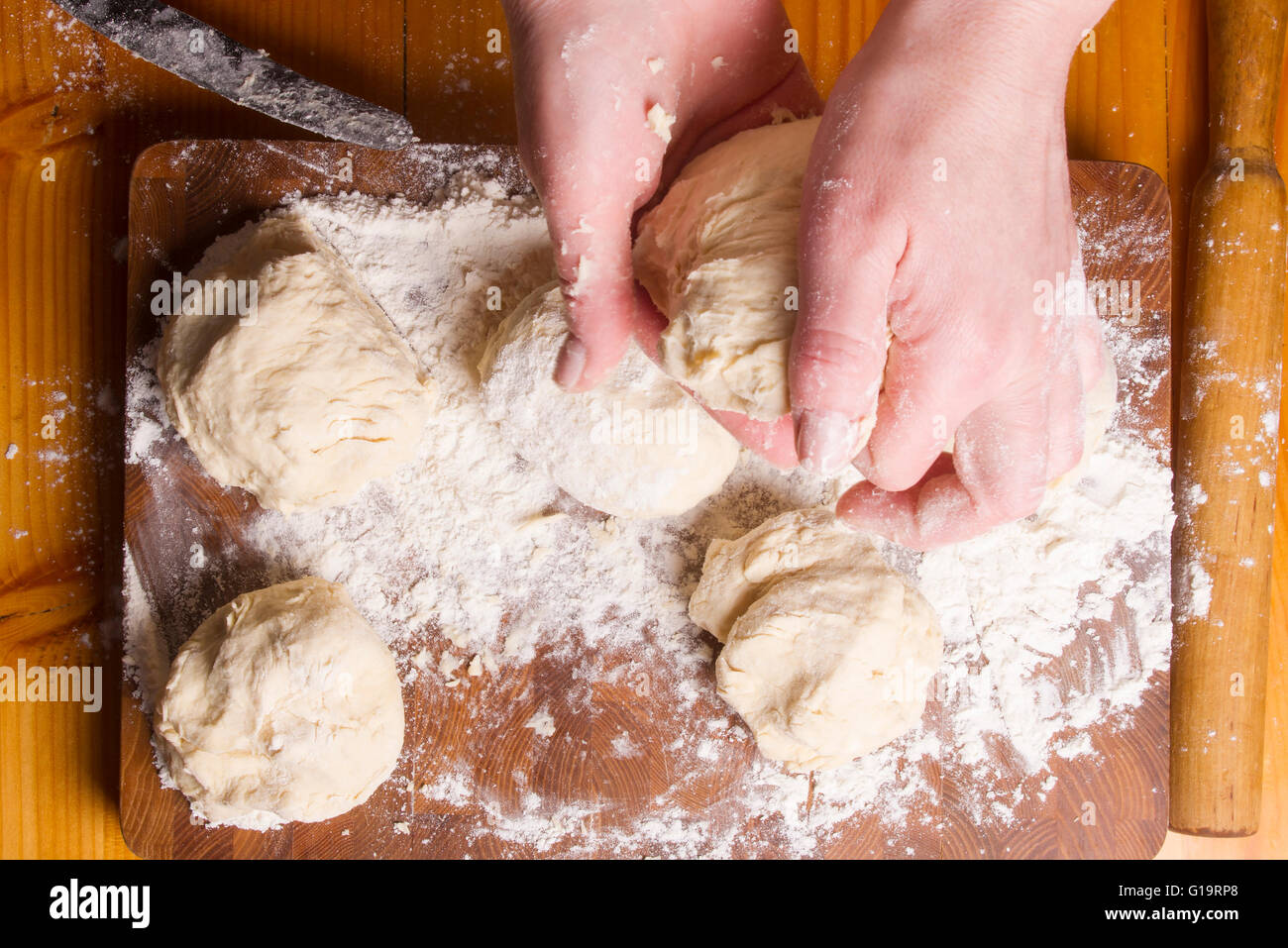 Making dough by female hands on wooden table background Stock Photo - Alamy