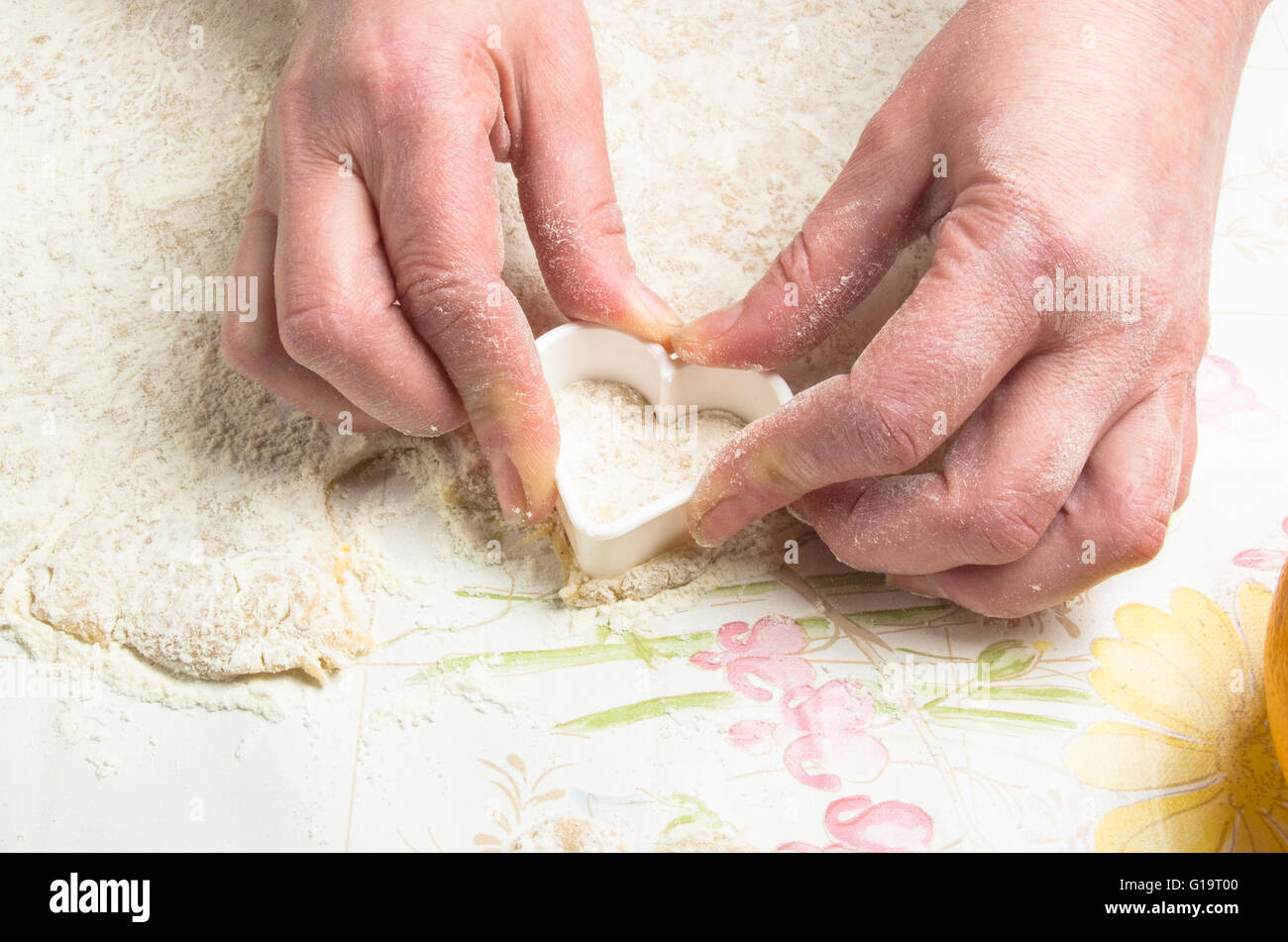 making homemade sugar cookies - woman's hands, form a dough and the ...