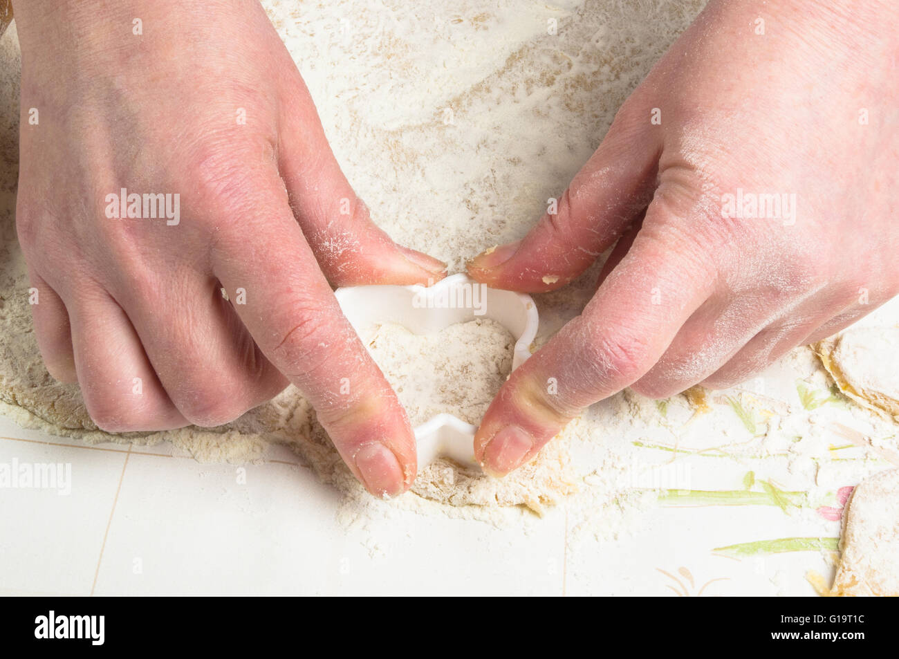 making homemade sugar cookies - woman's hands, form a dough and the ...