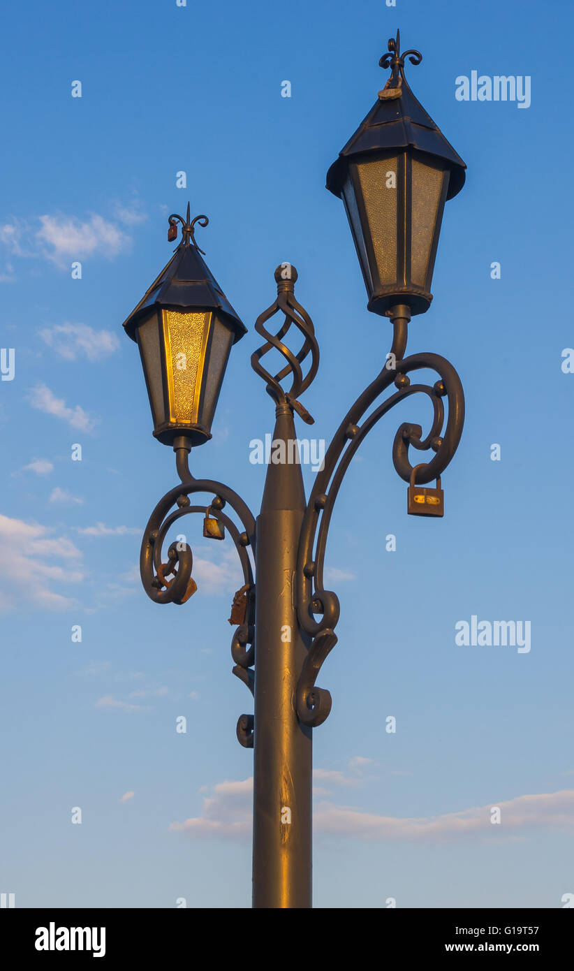city skyline - classic lamp post with locks of lovers at sunset Stock ...