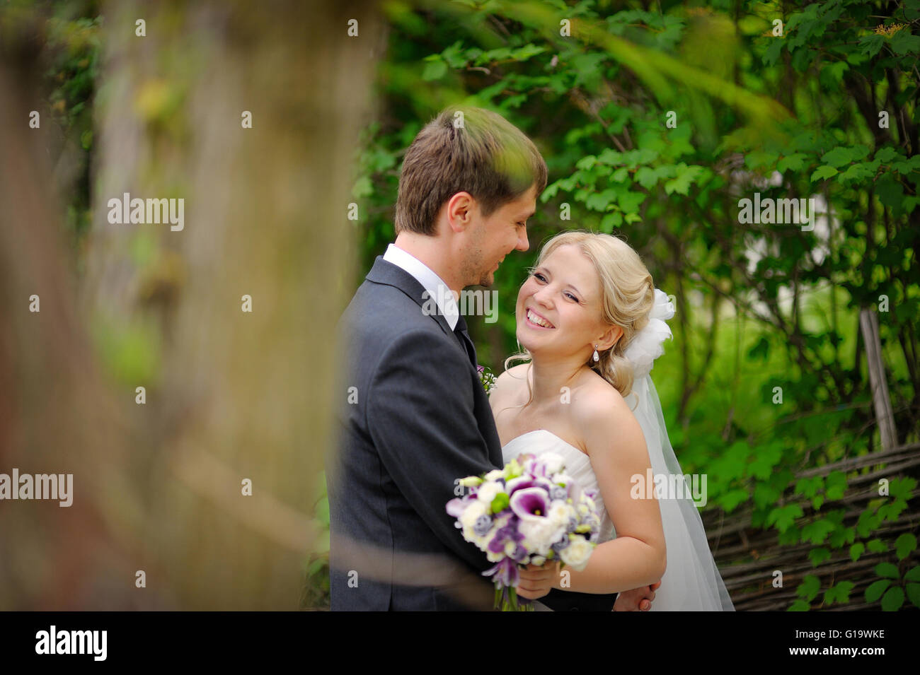 bride and groom walk in the park happy Stock Photo - Alamy