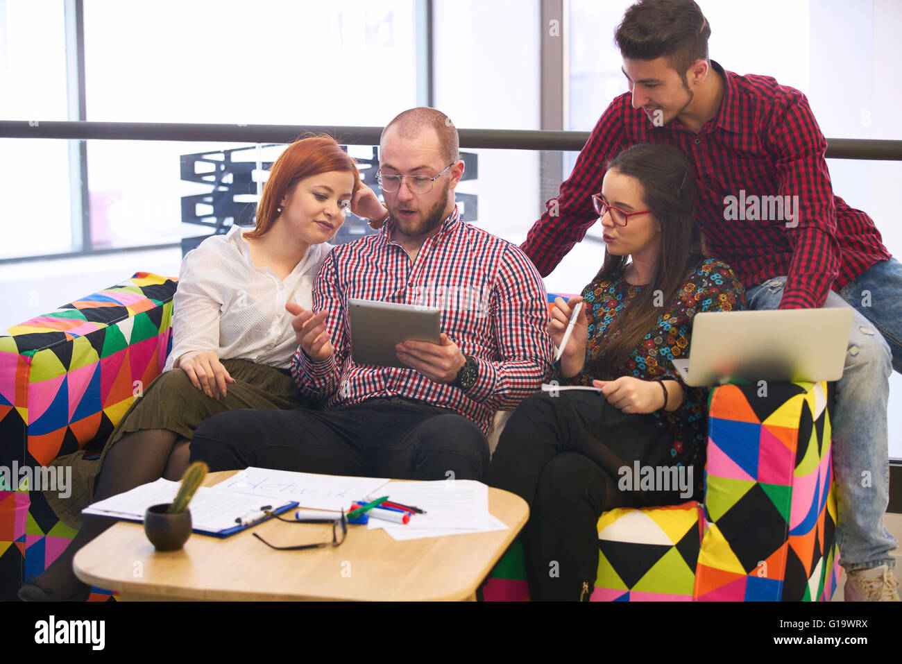 Group of young adults, brainstorming, business Stock Photo - Alamy