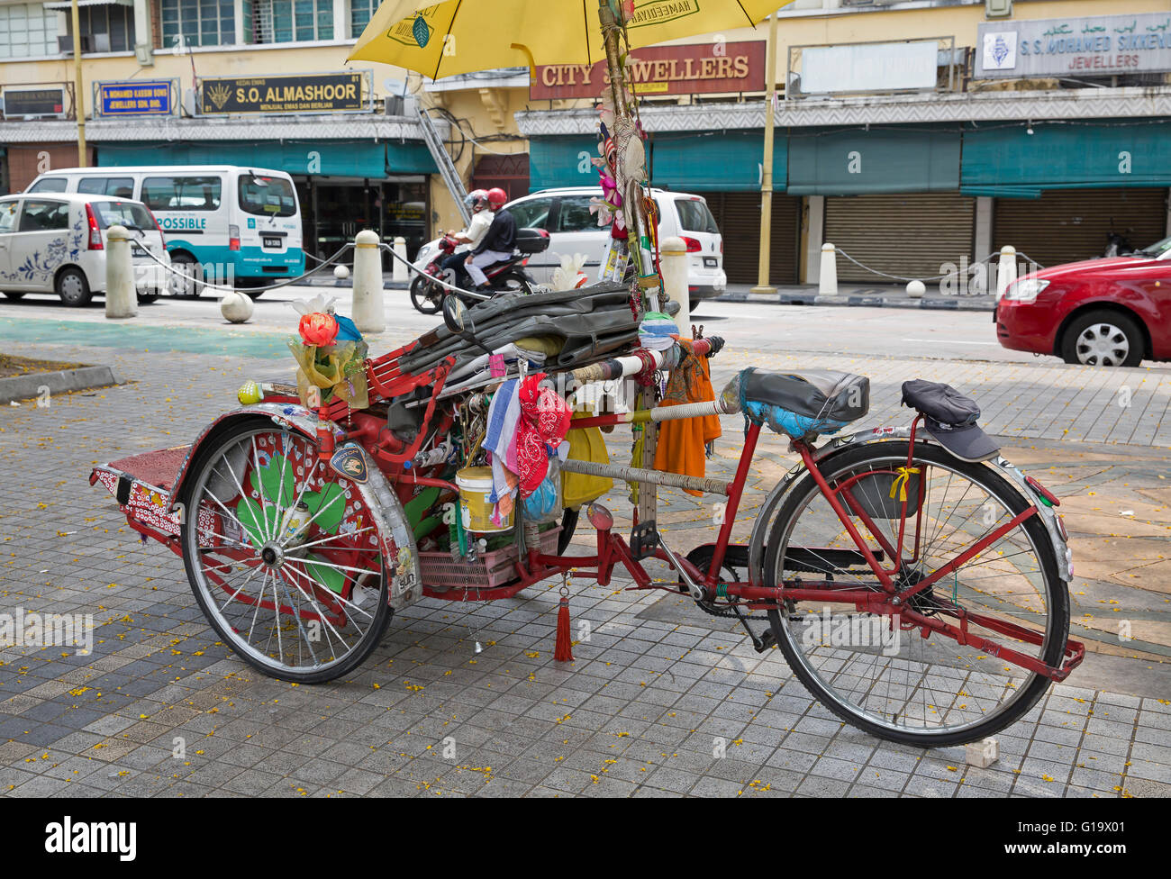 Tricycle taxi with an umbrella to shade passengers from the sunshine in ...