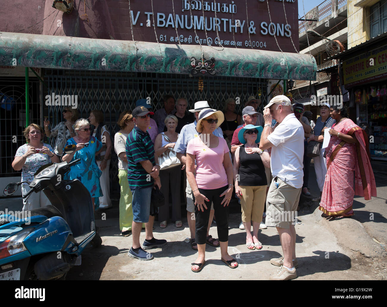 Tourists in a busy street in Chennai India which is crowded with people ...