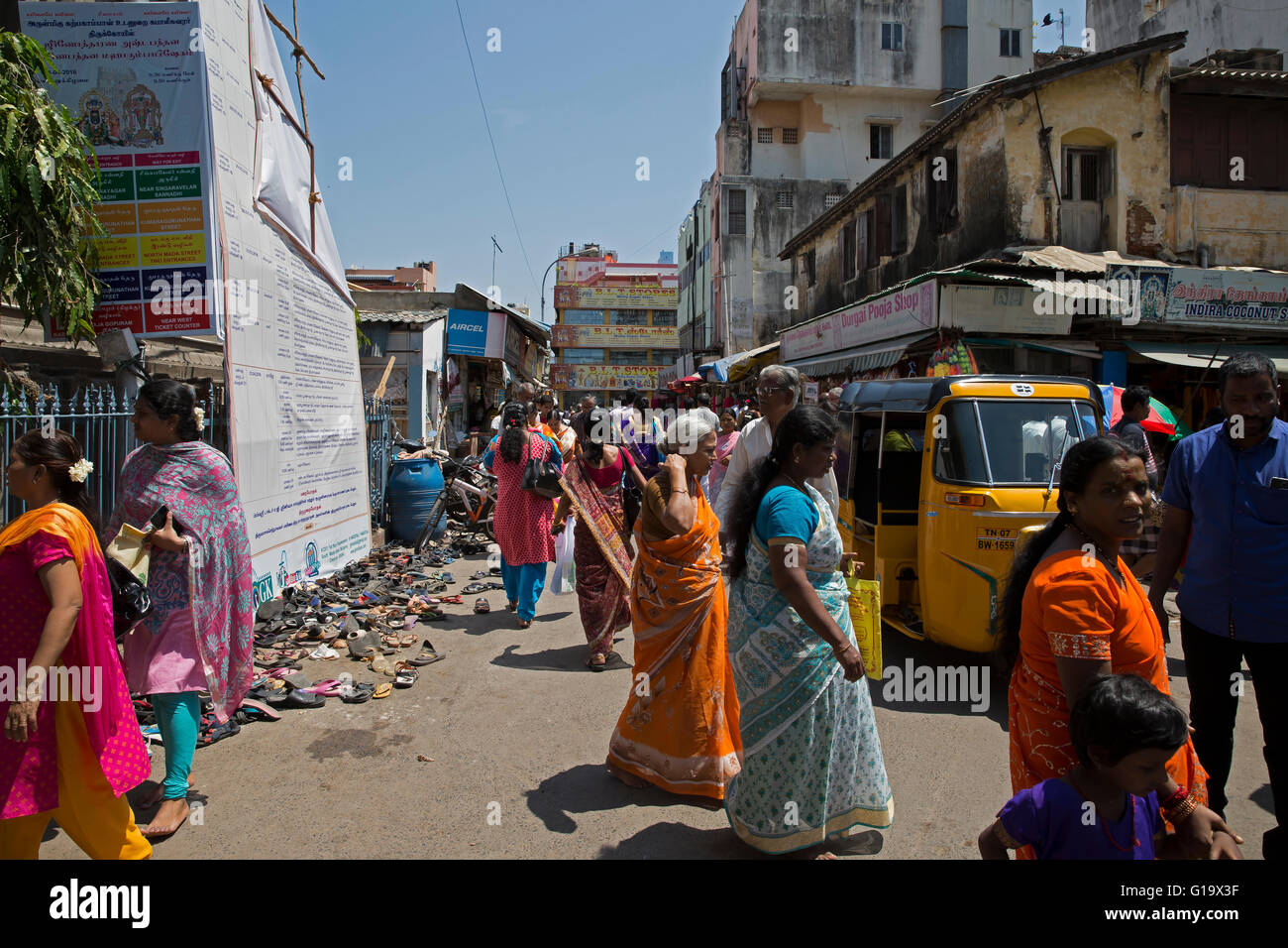 A busy street in Chennai India is crowded with people and traffic and ...