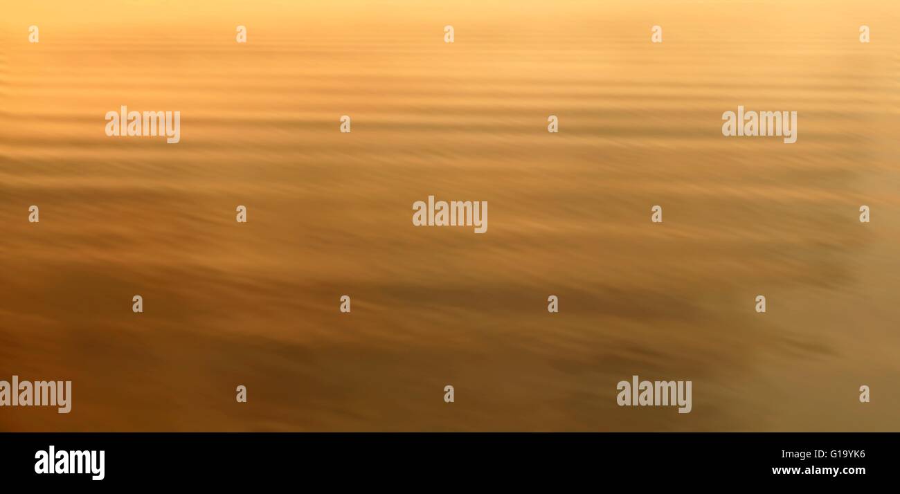Golden color water Reflections Stock Photo - Alamy