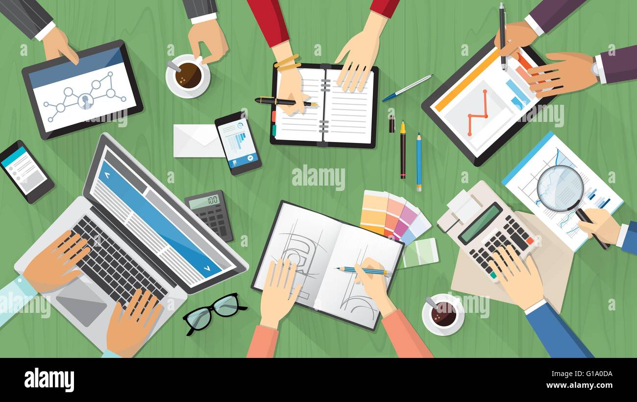 Creative team desktop top view with computer, tablets, stationery and ...