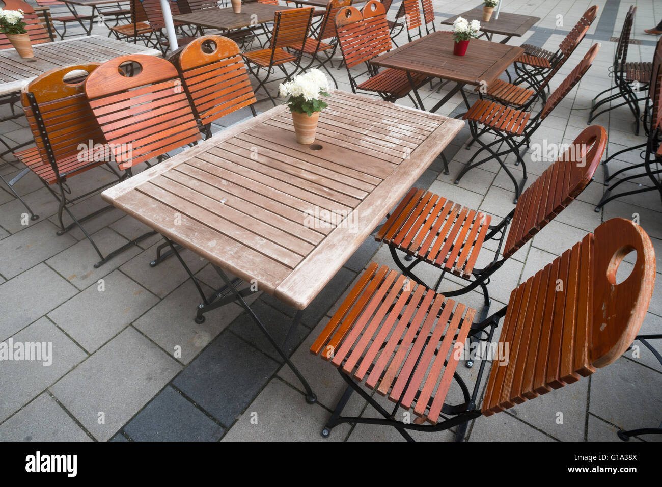 many empty tables and chairs outdoor with focus on flower pot Stock ...