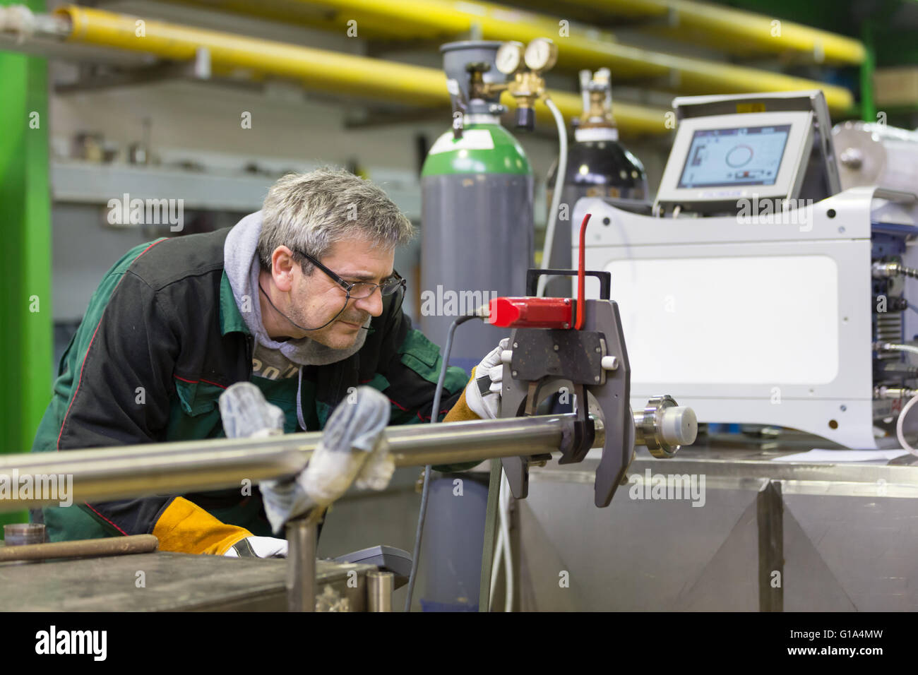 Industrial worker setting orbital welding machine Stock Photo - Alamy