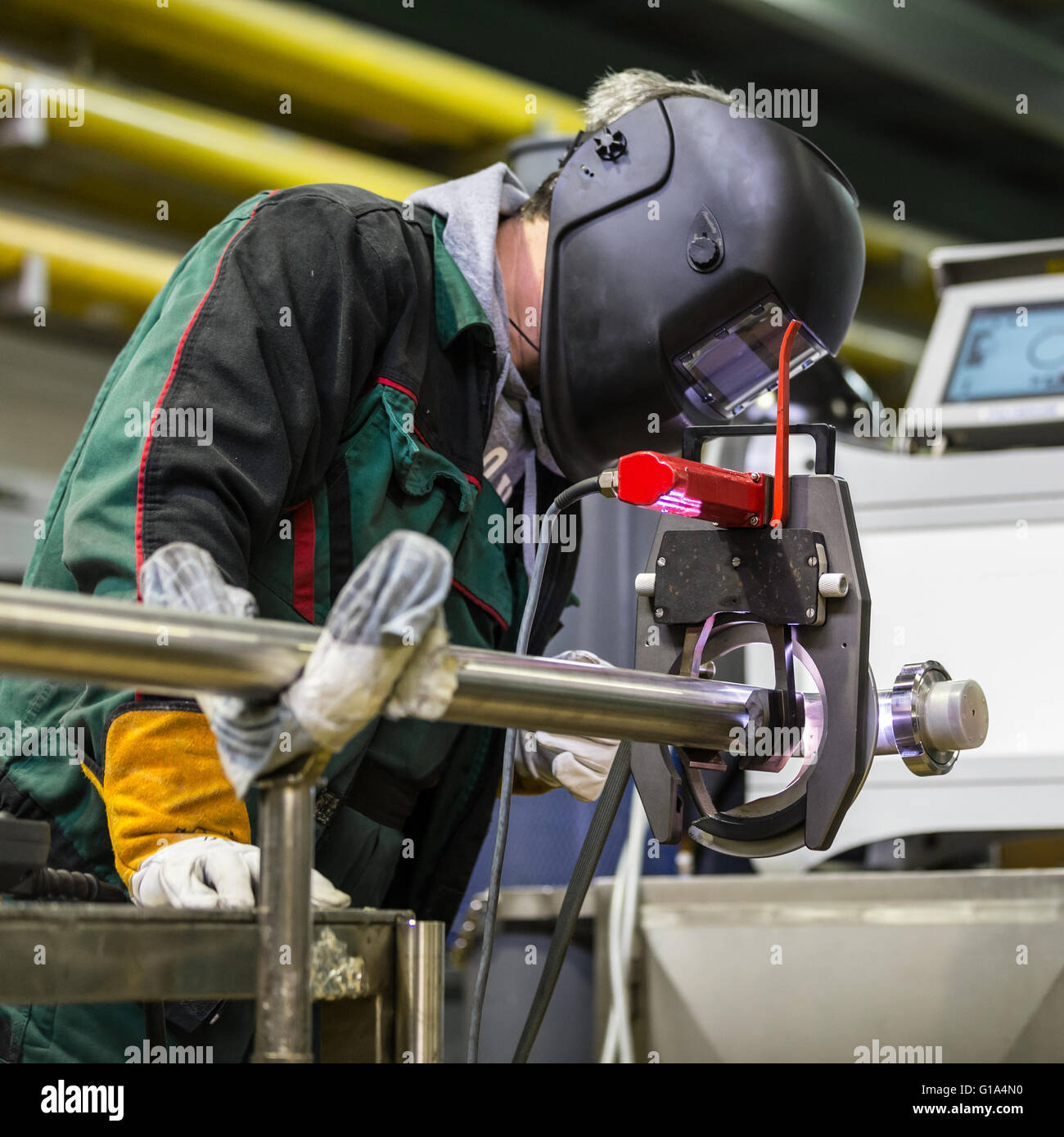 Industrial worker setting orbital welding machine Stock Photo - Alamy
