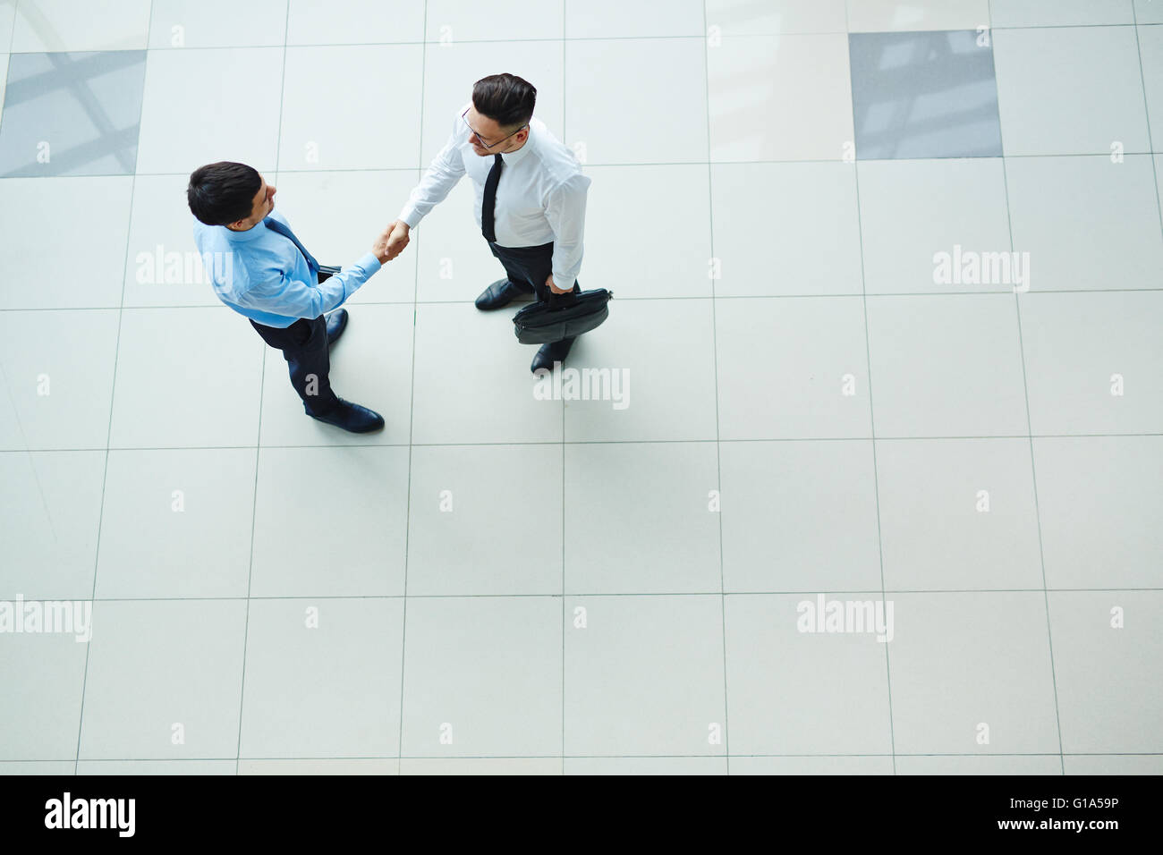 Successful businessmen greeting one another by handshake Stock Photo ...