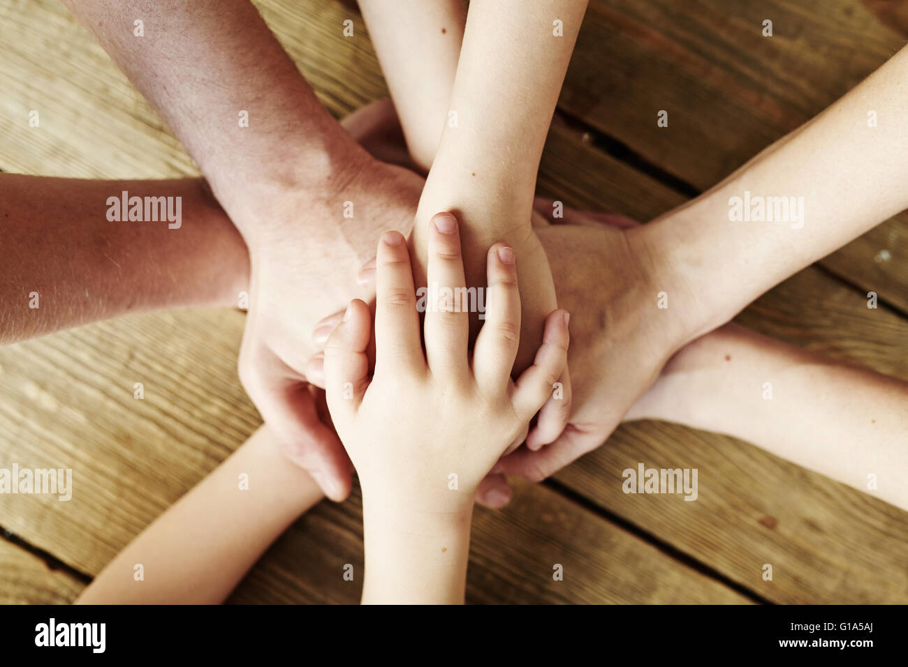 Hands of daughters and father making pile Stock Photo - Alamy