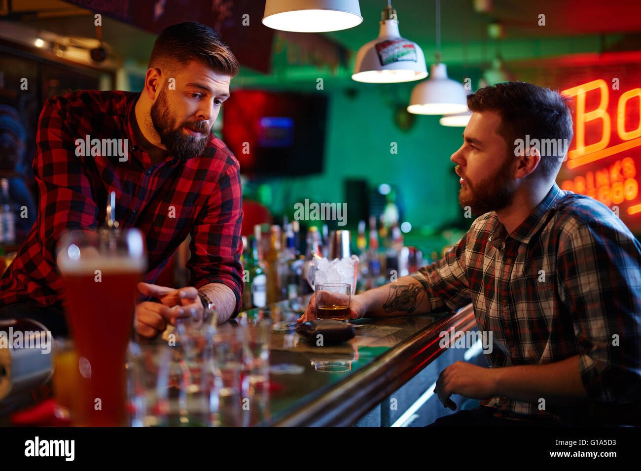 Young barman and client talking in bar Stock Photo - Alamy
