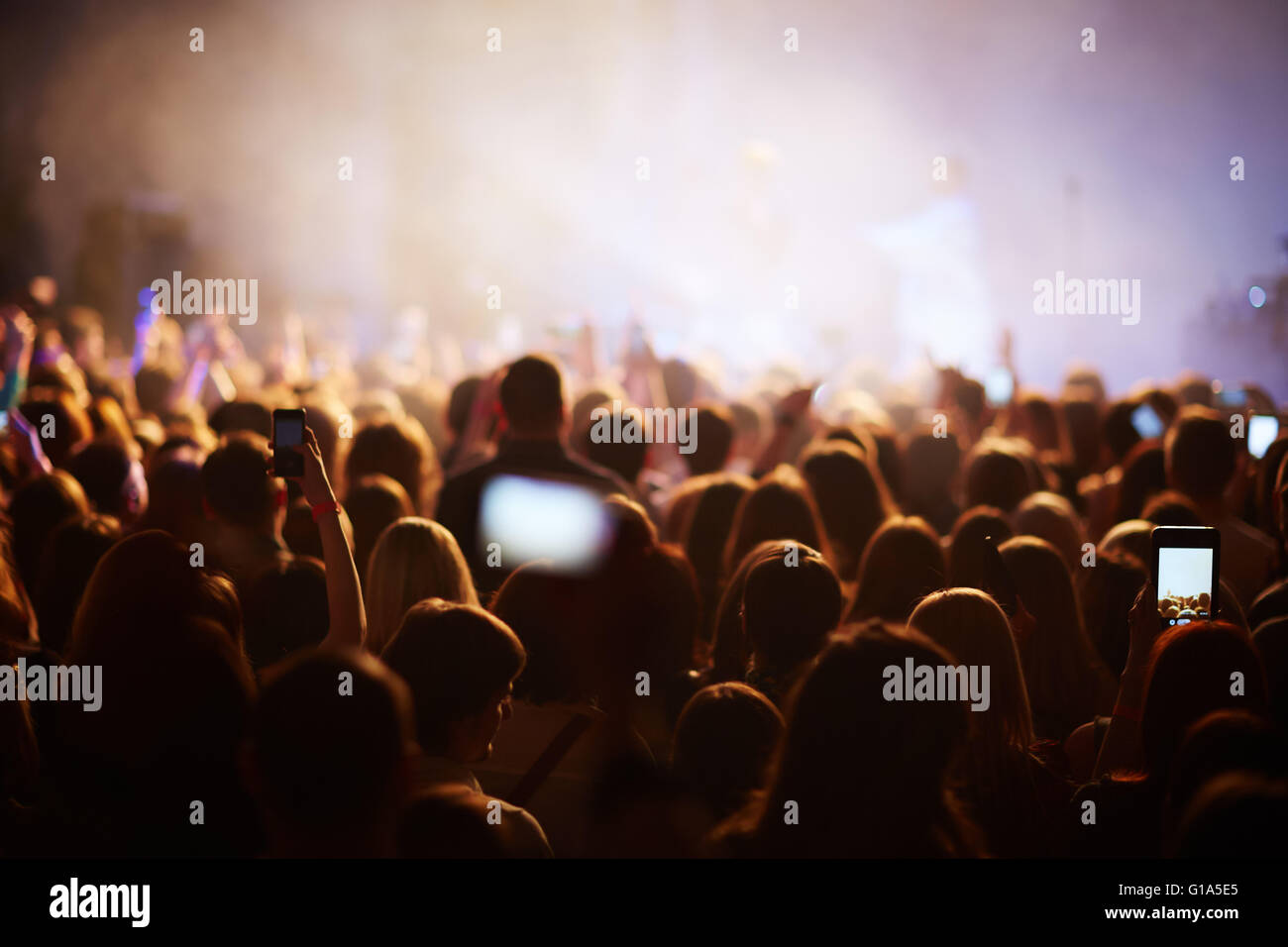 Crowd of fans making photos of concert of their favorite performer ...