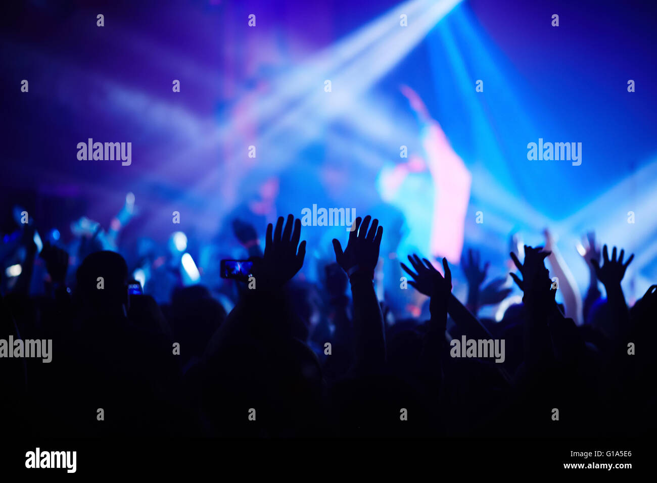 Crowd of ecstatic fans with raised hands greeting their favorite ...
