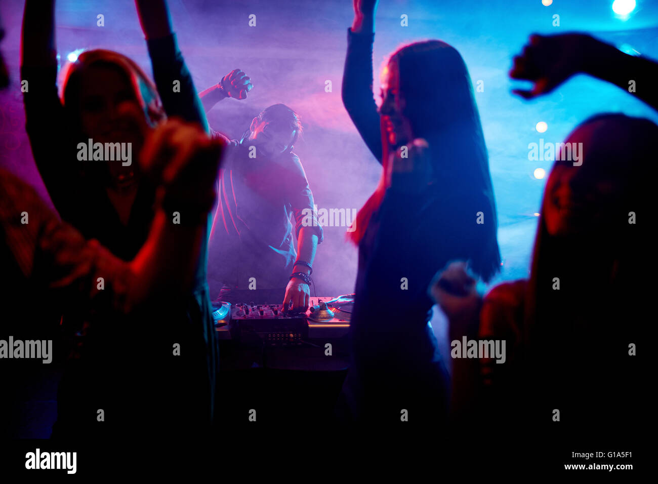 Group of dancing friends enjoying disco on background of deejay Stock ...