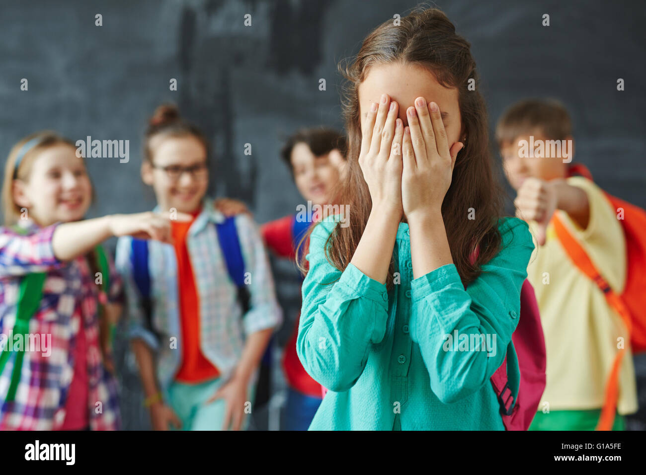 Unhappy schoolgirl crying classmates teasing hi-res stock photography ...