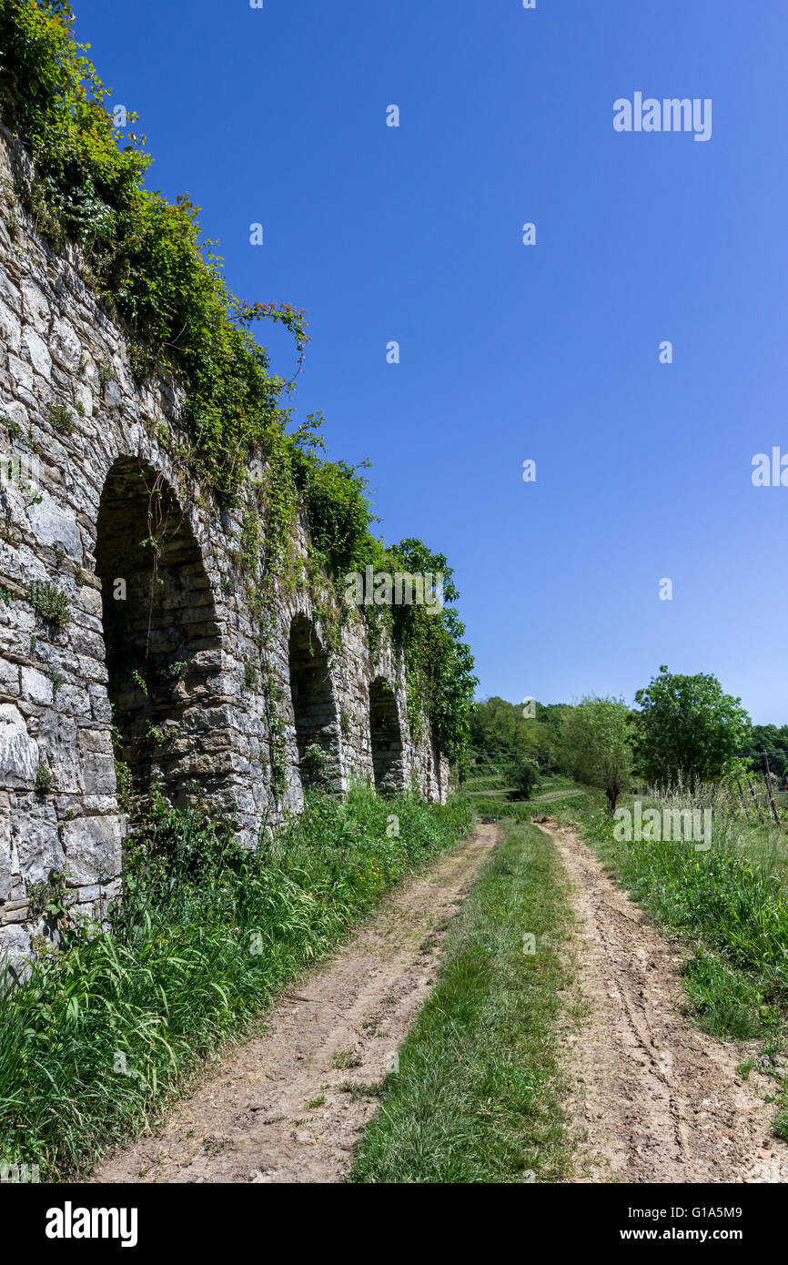 Footpath in countryside with ancient medieval wall Stock Photo - Alamy