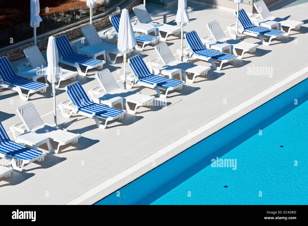Hotel Poolside Chairs near a swimming pool. Summer shot Stock Photo - Alamy