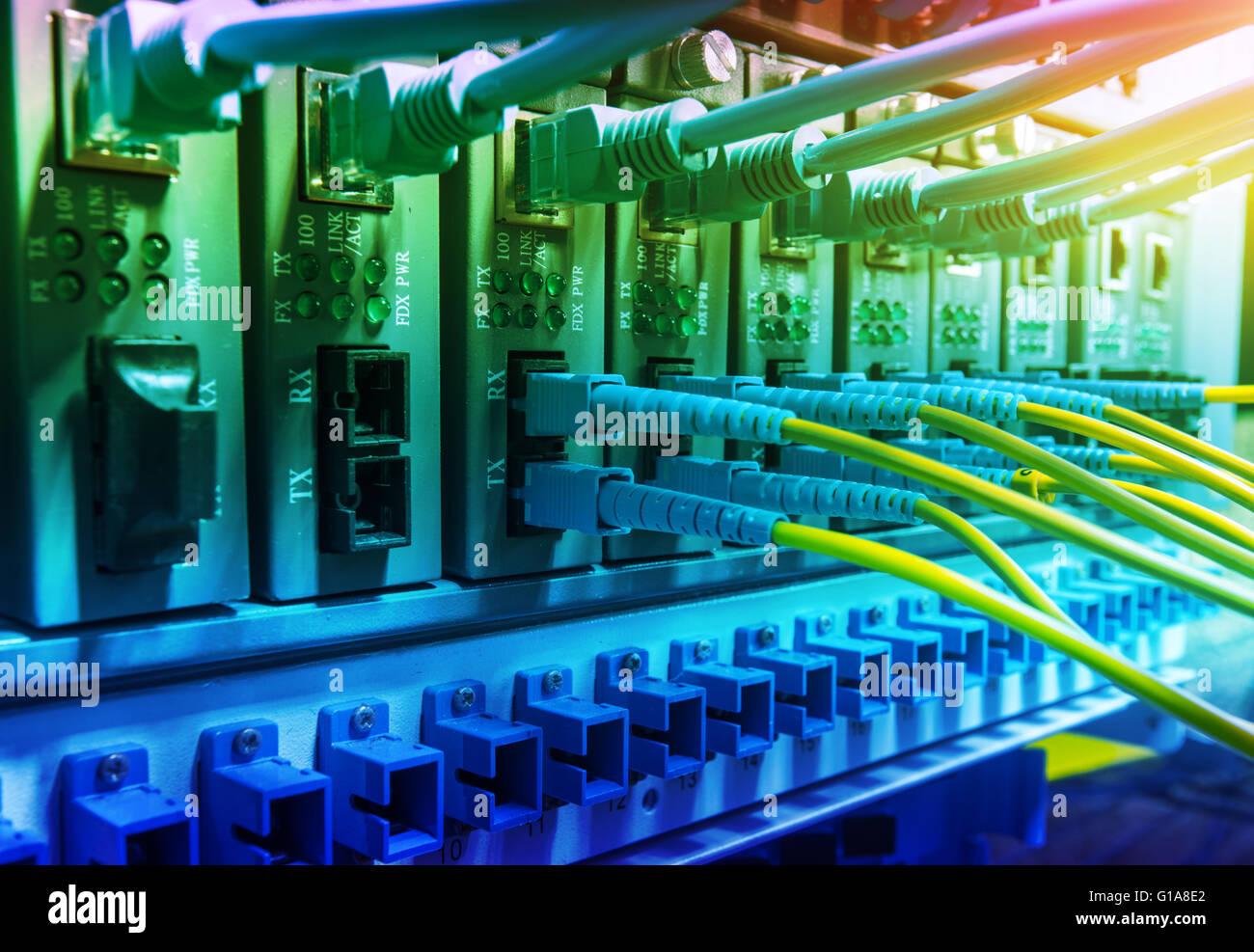 Fiber Optic cables connected to an optic ports and Network cables ...