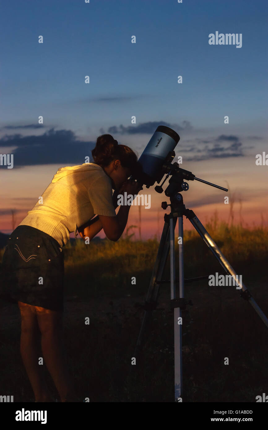 Girl watching through a Skywatcher telescope mounted on a simple ...