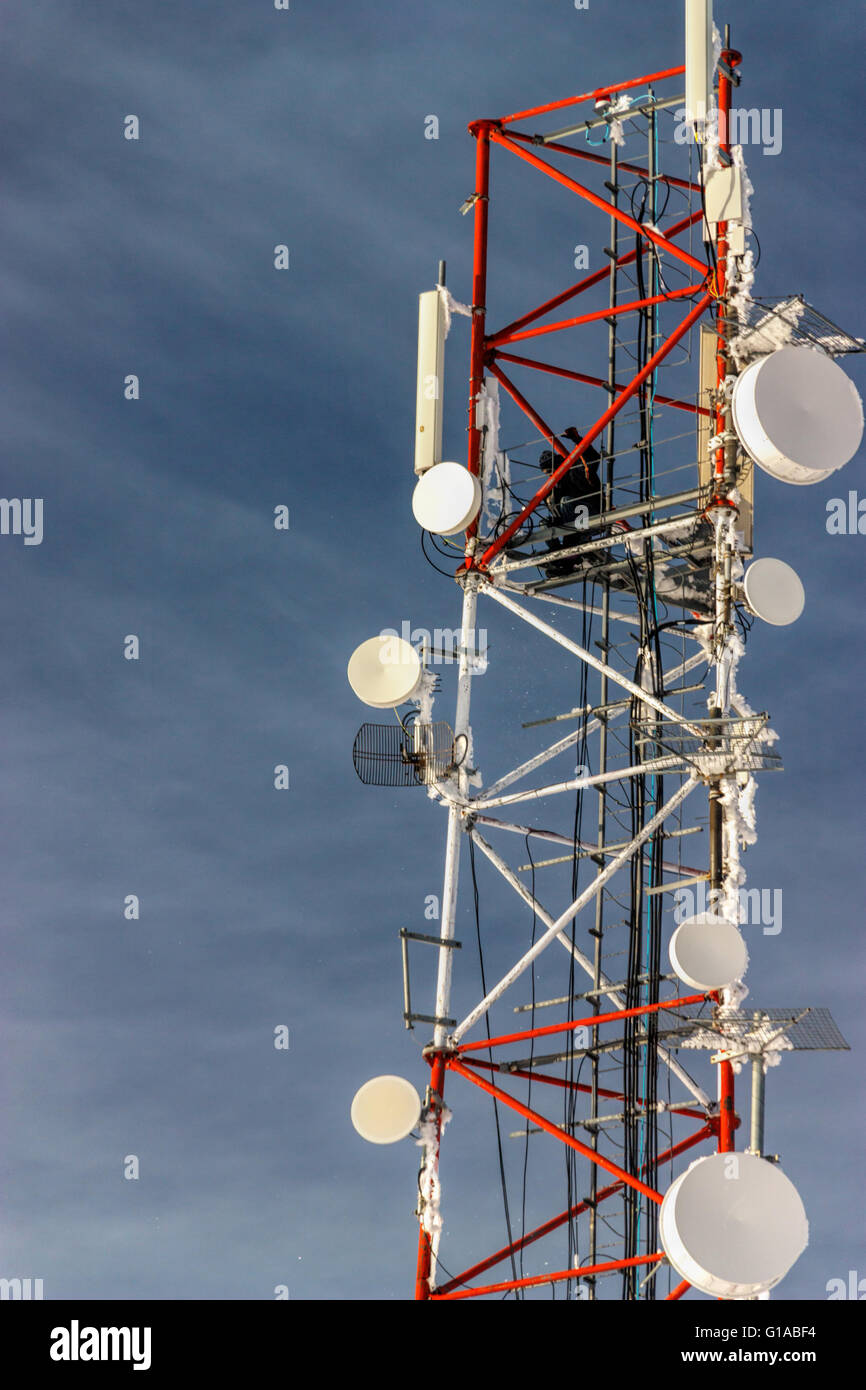 man working at Pylon radio telecommunication and radar antenna on top ...