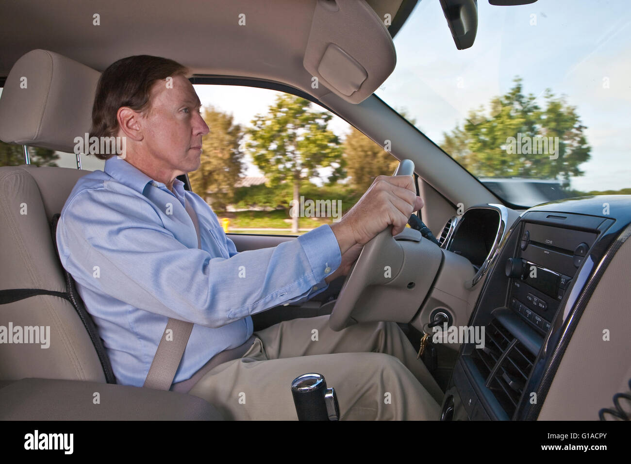 Passenger seat view of older man driving SUV Stock Photo - Alamy
