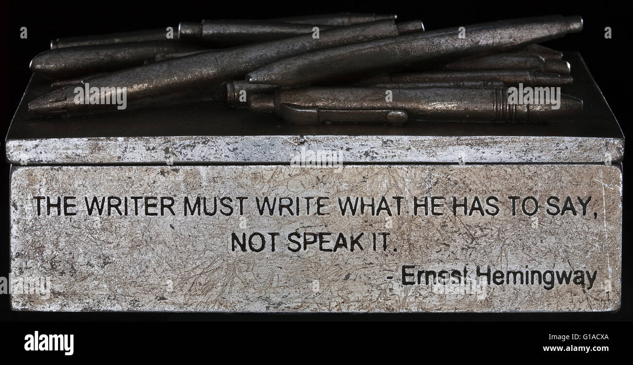 Metal pen and pencil box with hemingway quote Stock Photo - Alamy