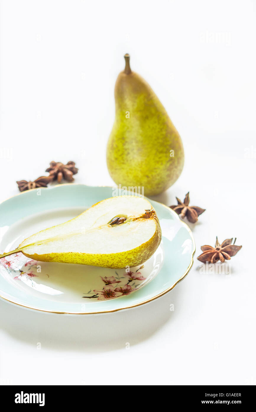 Pear on a plate, light background Stock Photo - Alamy