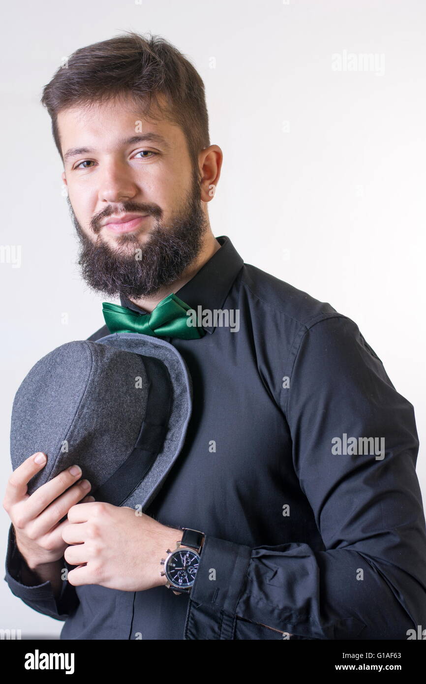 Fashionable man in a black shirt with a bow tie Stock Photo - Alamy
