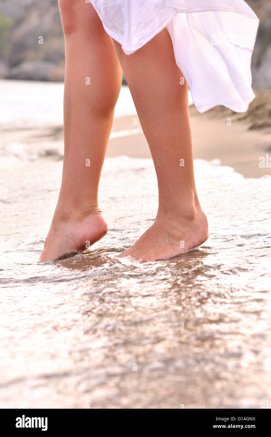 female legs on sunrise beach Stock Photo - Alamy